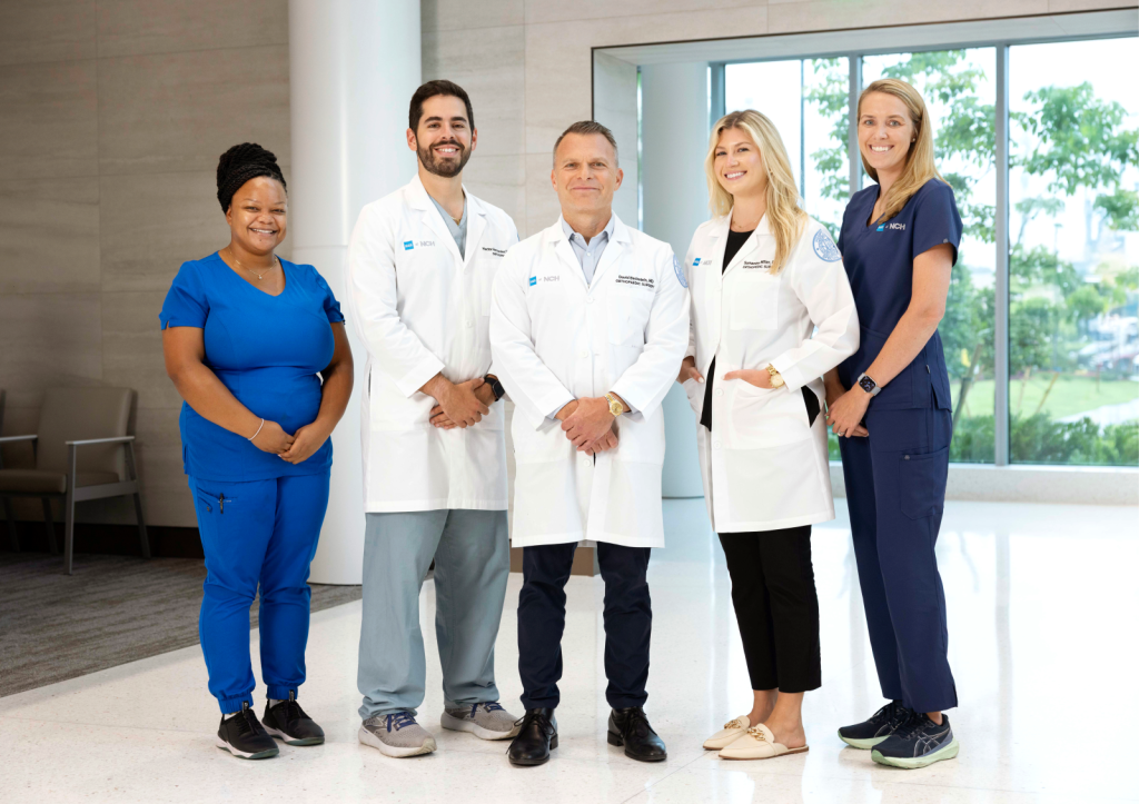 Team of smiling orthopedic specialists, surgeons, physicians assistants ...